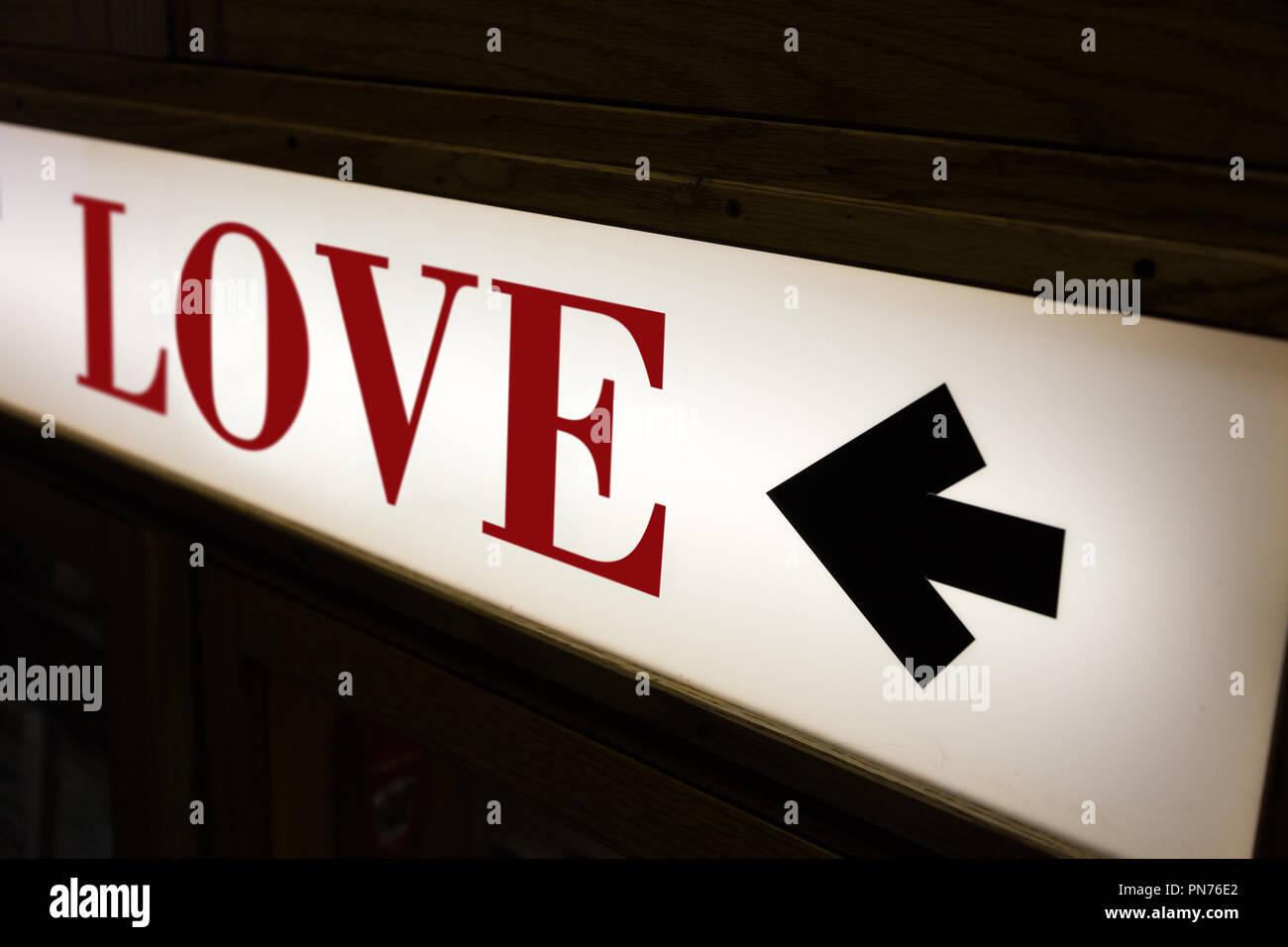 sign of word love and direction arrow Stock Photo - Alamy
