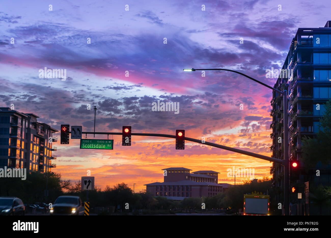 Dramatic sunset in North Scottsdale,Arizona. Cars drive by a busy ...