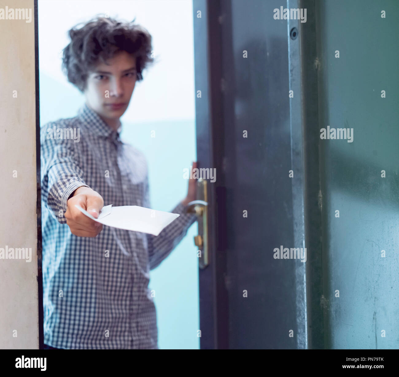 young postman brings the letter envelope delivery to home Stock Photo ...