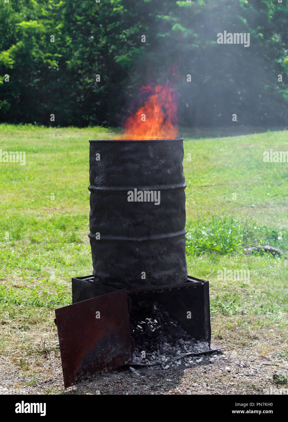 large bin with fire to the production of the embers to make a cheerful ...