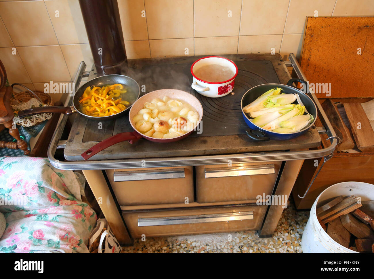 many pots on the wood burning stove in the kitchen of an old house ...