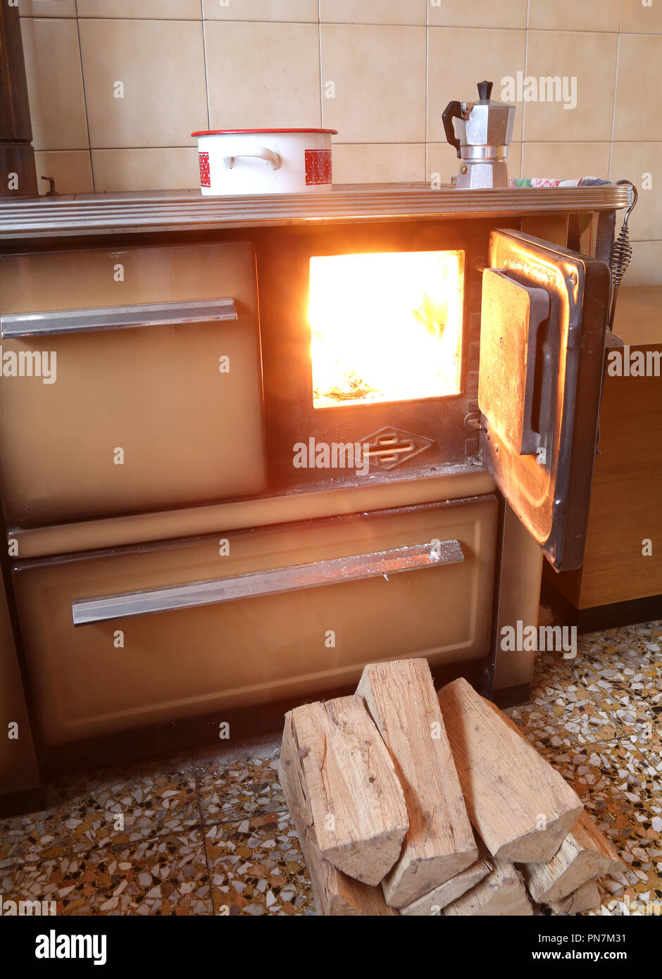 ancient wood-burning stove inside a kitchen of the house with fire ...