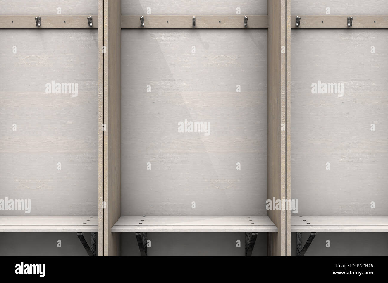 Empty wooden cubicles with a bench and hangers in a rundown sports ...