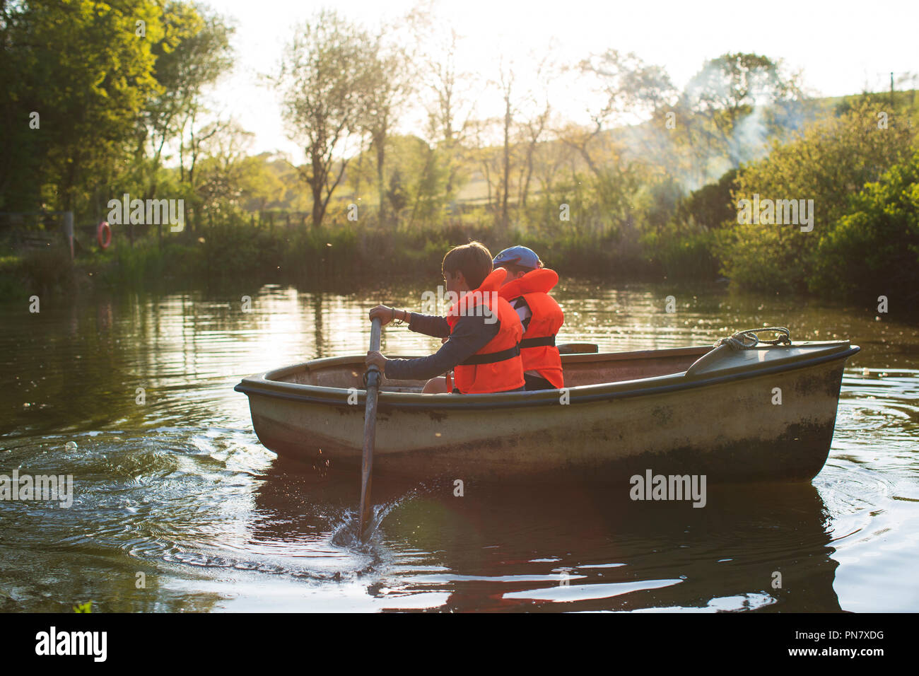 Two boys on boat hi-res stock photography and images - Alamy