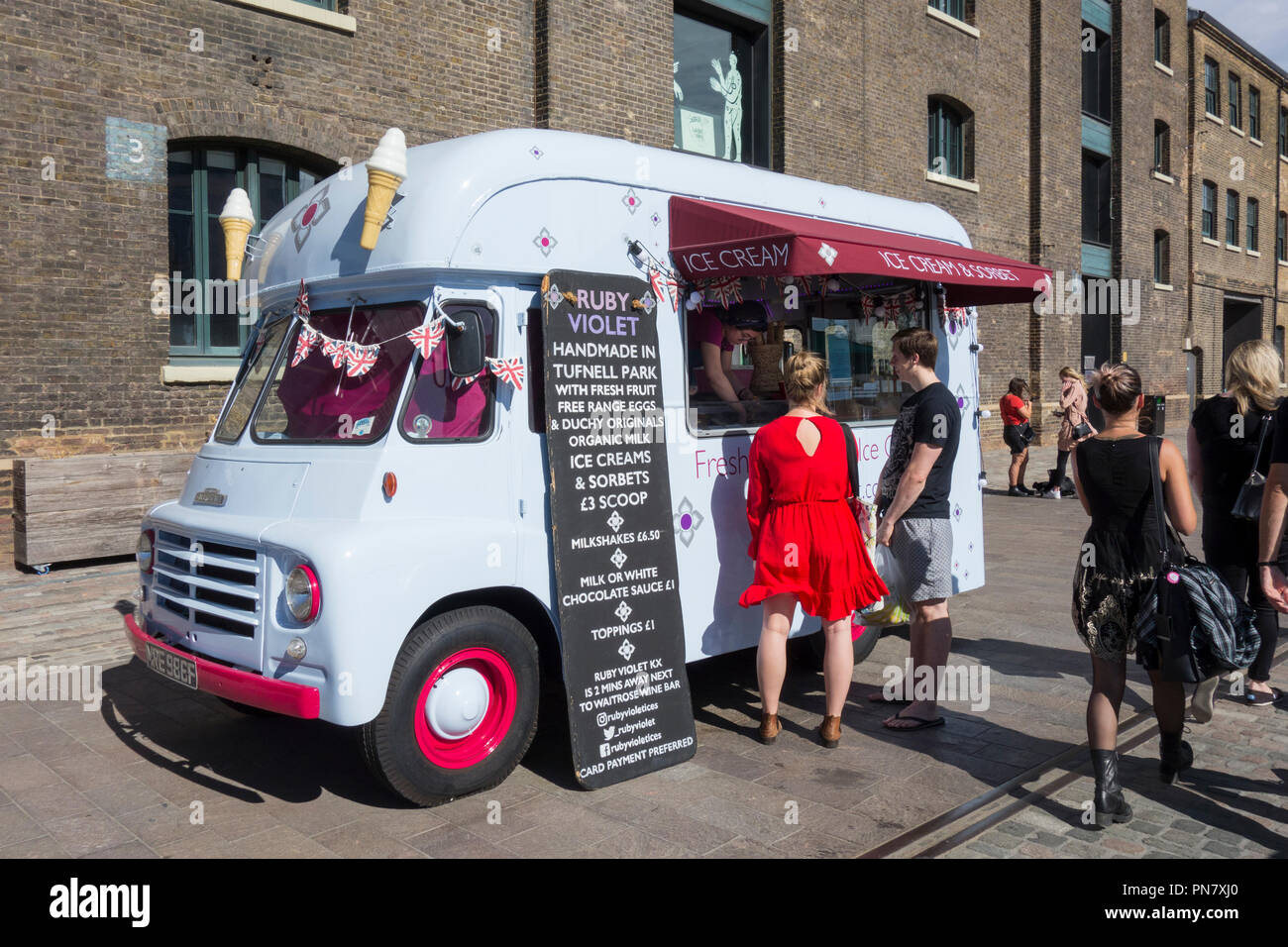 A young couple buying an ice cream from Ruby Violet's ice cream van in ...