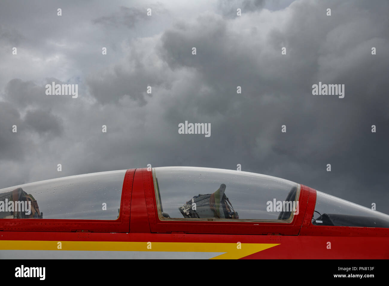 Profile of jet plane cockpit against dark cloudy sky Stock Photo - Alamy