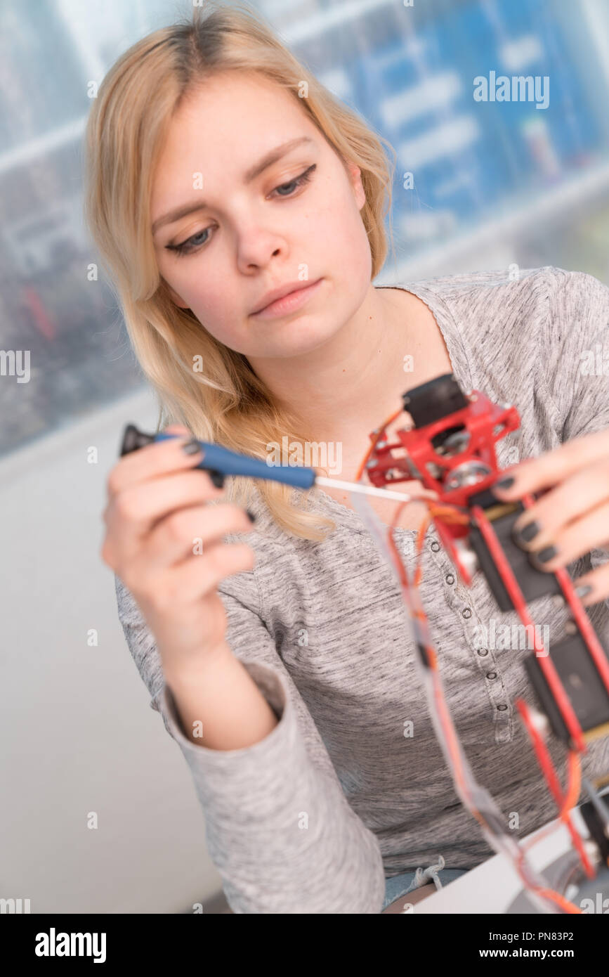 Young attractive female engineer working on robotics project Stock ...