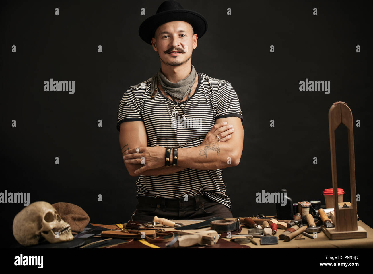 Craftsman posing on his working place with crafting tools Stock Photo ...