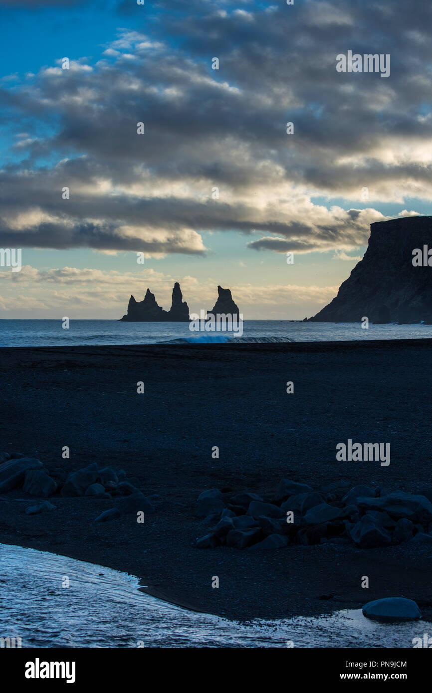 Reynisdrangar basalt sea stacks (troll rocks) and black volcanic sand ...