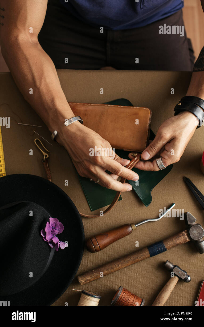 Close-up. Male hand master cut with a knife to skin products. Small ...