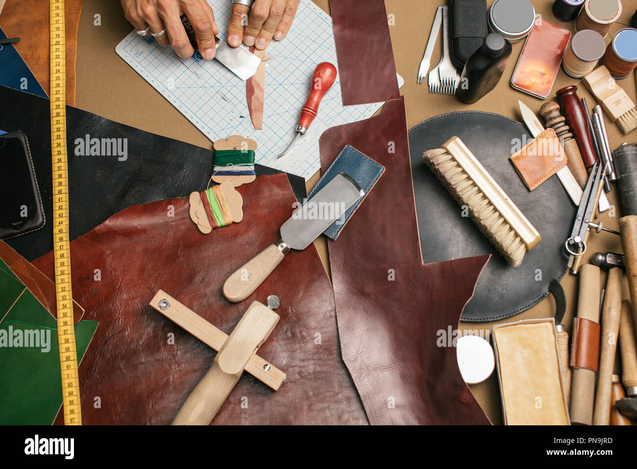 Close-up. Male hand master cut with a knife to skin products. Small ...