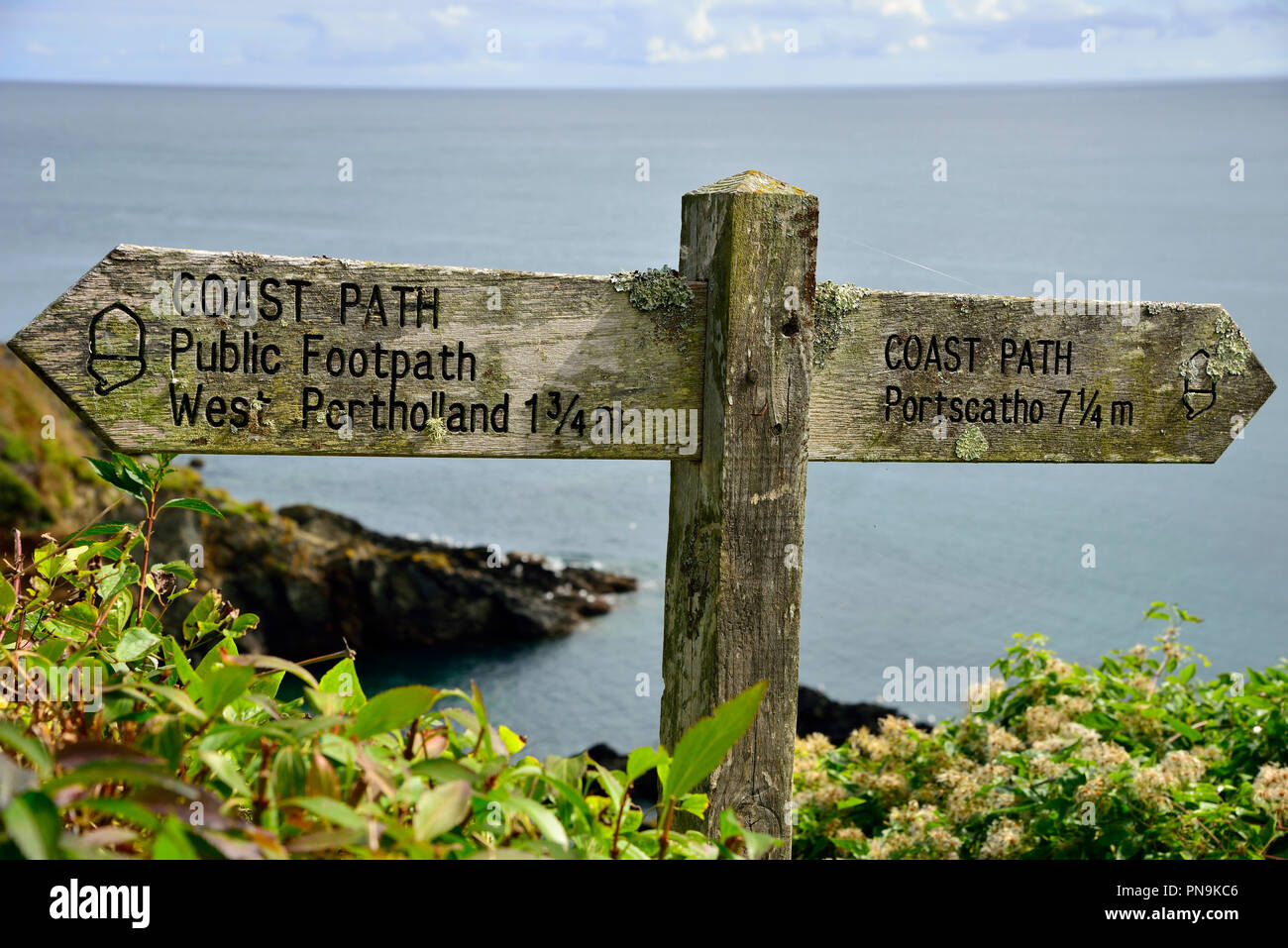Coast Path wooden signpost outside the Cornish village of Portloe on ...
