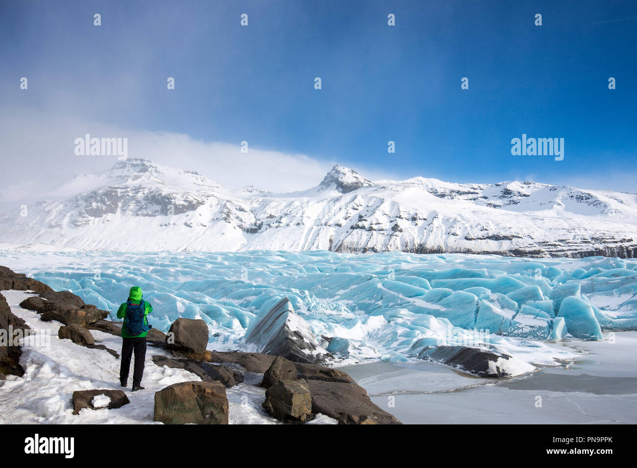 Tourist photographs glacial tongue of Svinafellsjokull glacier an ...