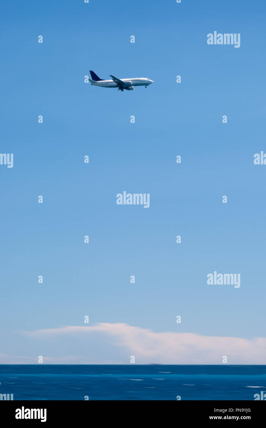 Low flying jet plane over the sea, with a pan blur Stock Photo - Alamy