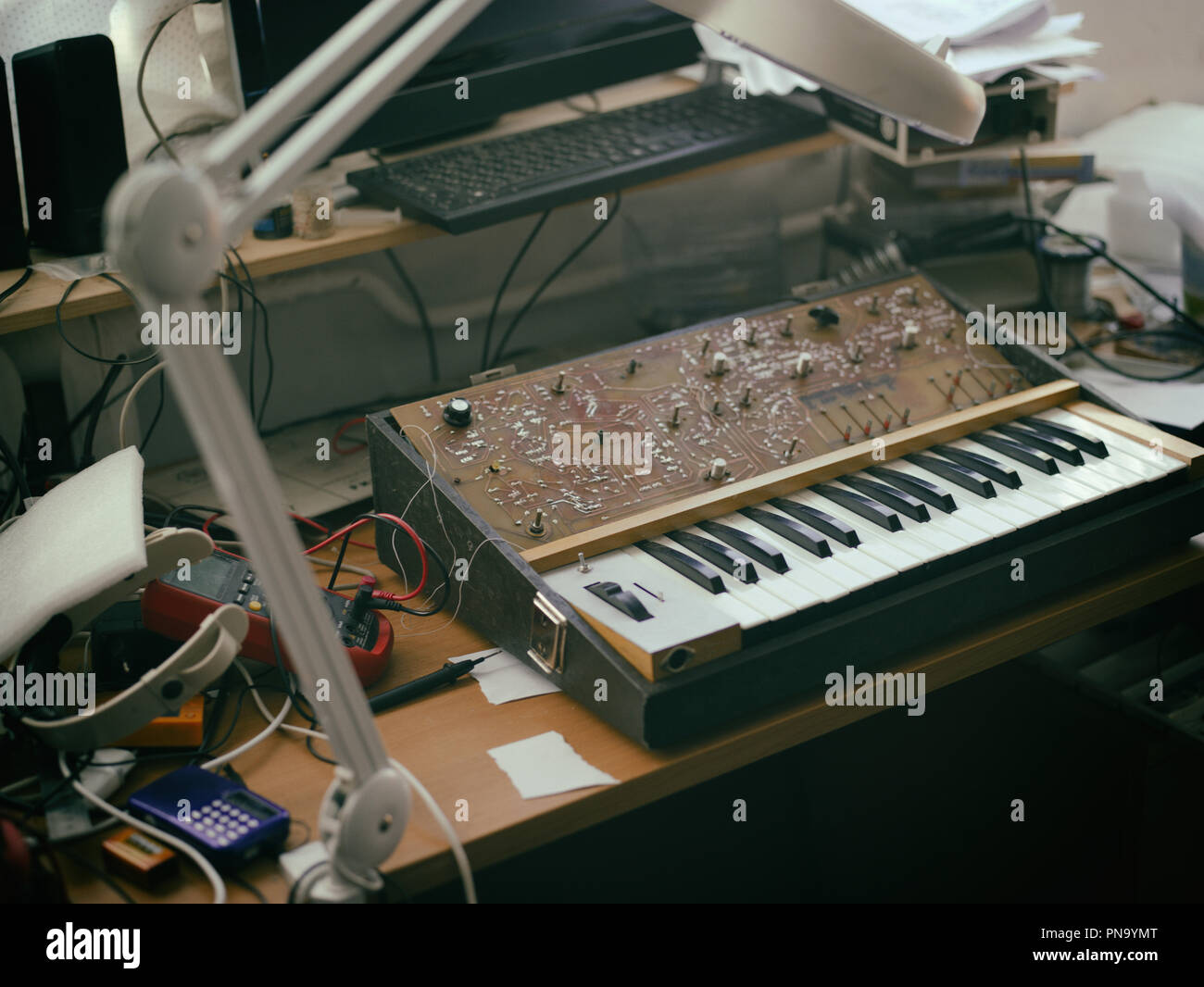 Musical electronic keyboard repair, a messy workplace in the background ...