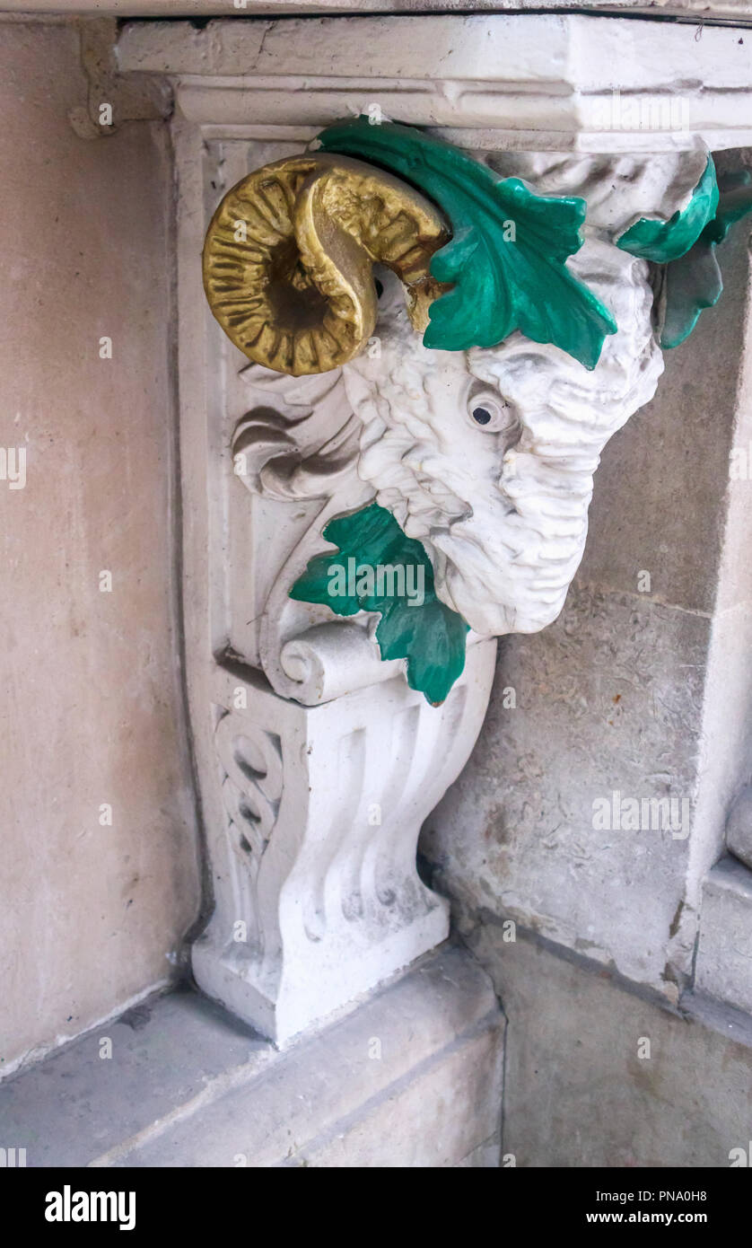 Architectural detail: stucco work ram's head with gilded horns on a ...