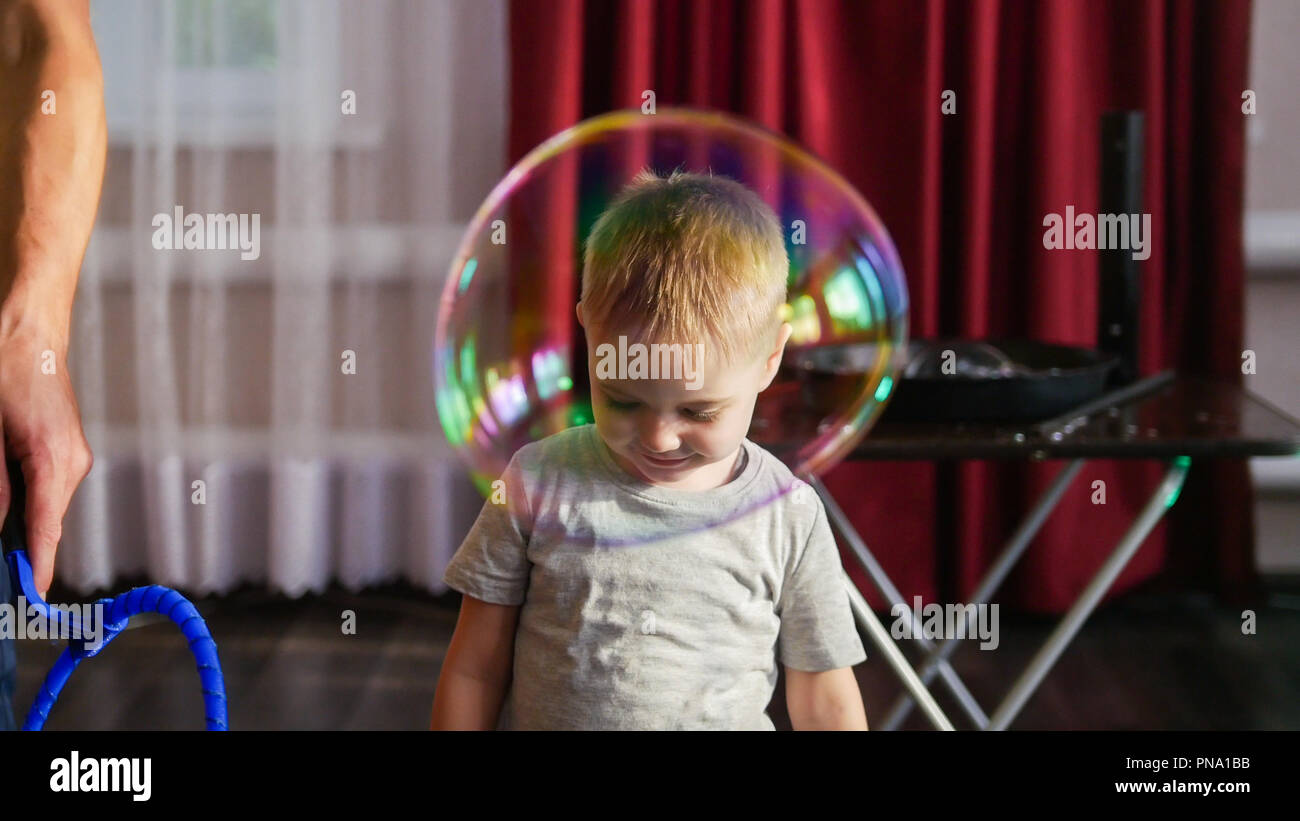 Cute smiling baby with big soap bubble Stock Photo - Alamy