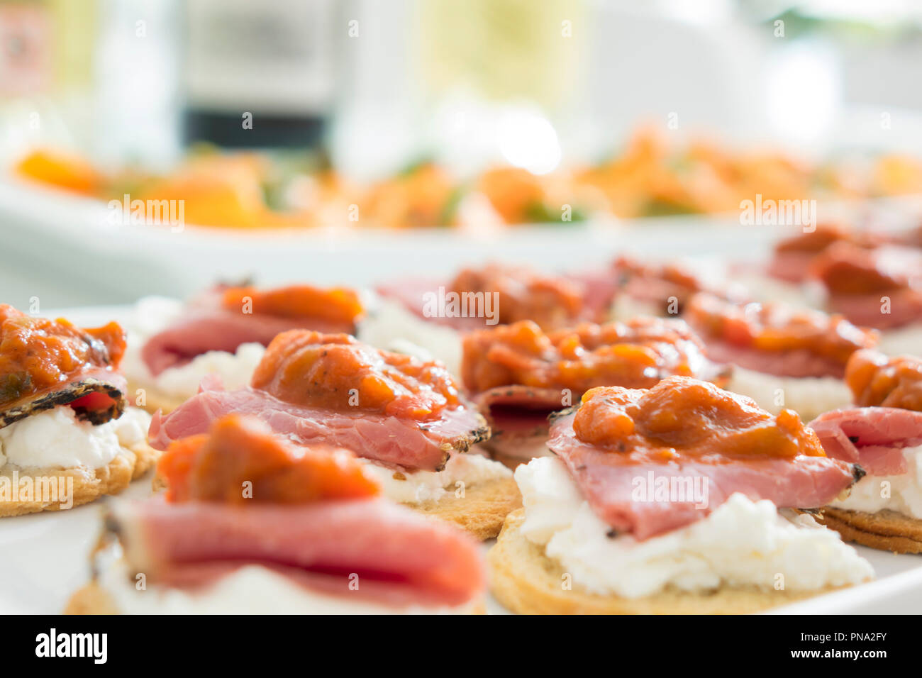 Canape with smoked meat, cheese and tomato sauce Stock Photo - Alamy