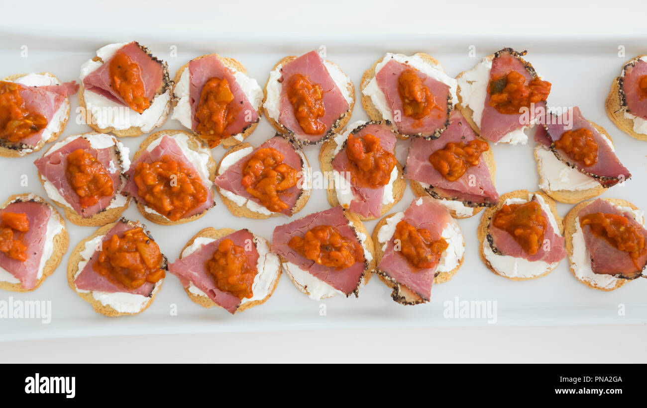 Canape with smoked meat, cheese and tomato sauce Stock Photo - Alamy