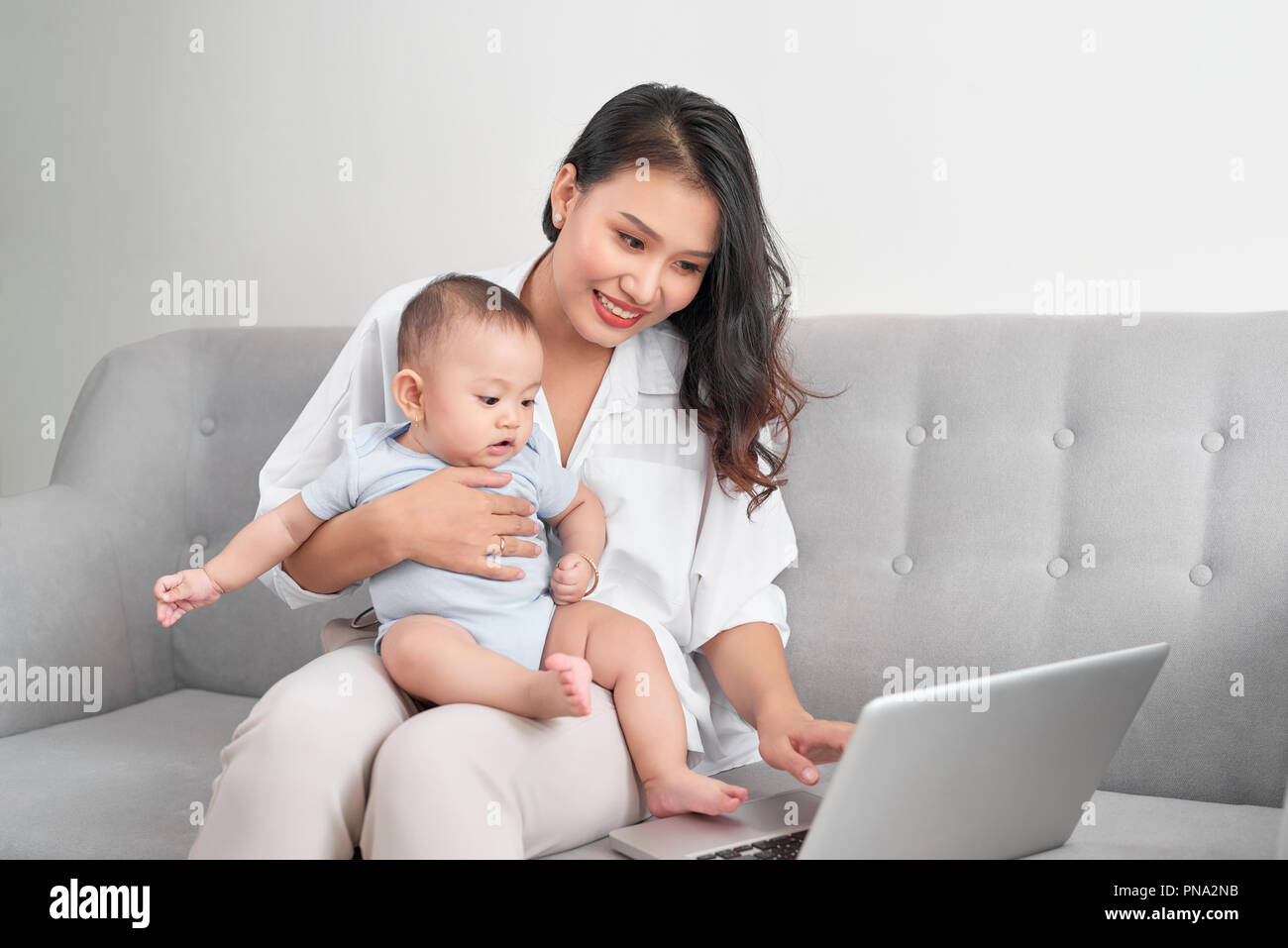 Mother baby using laptop computer hi-res stock photography and images ...