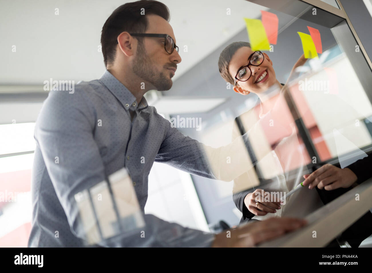 Business people meeting at office and use post it notes to share idea ...