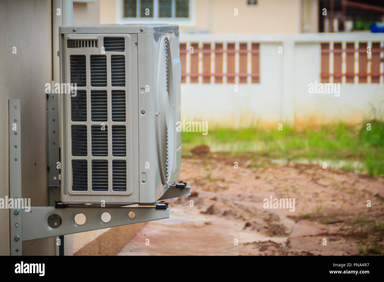 New Air conditioner compressor installed outside the house on the white ...