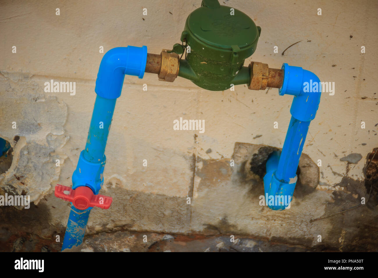 Vintage water meter installed with bronze joint, PVC elbow connector ...