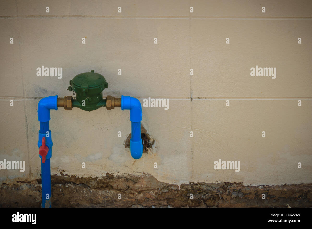 Vintage water meter installed with bronze joint, PVC elbow connector ...