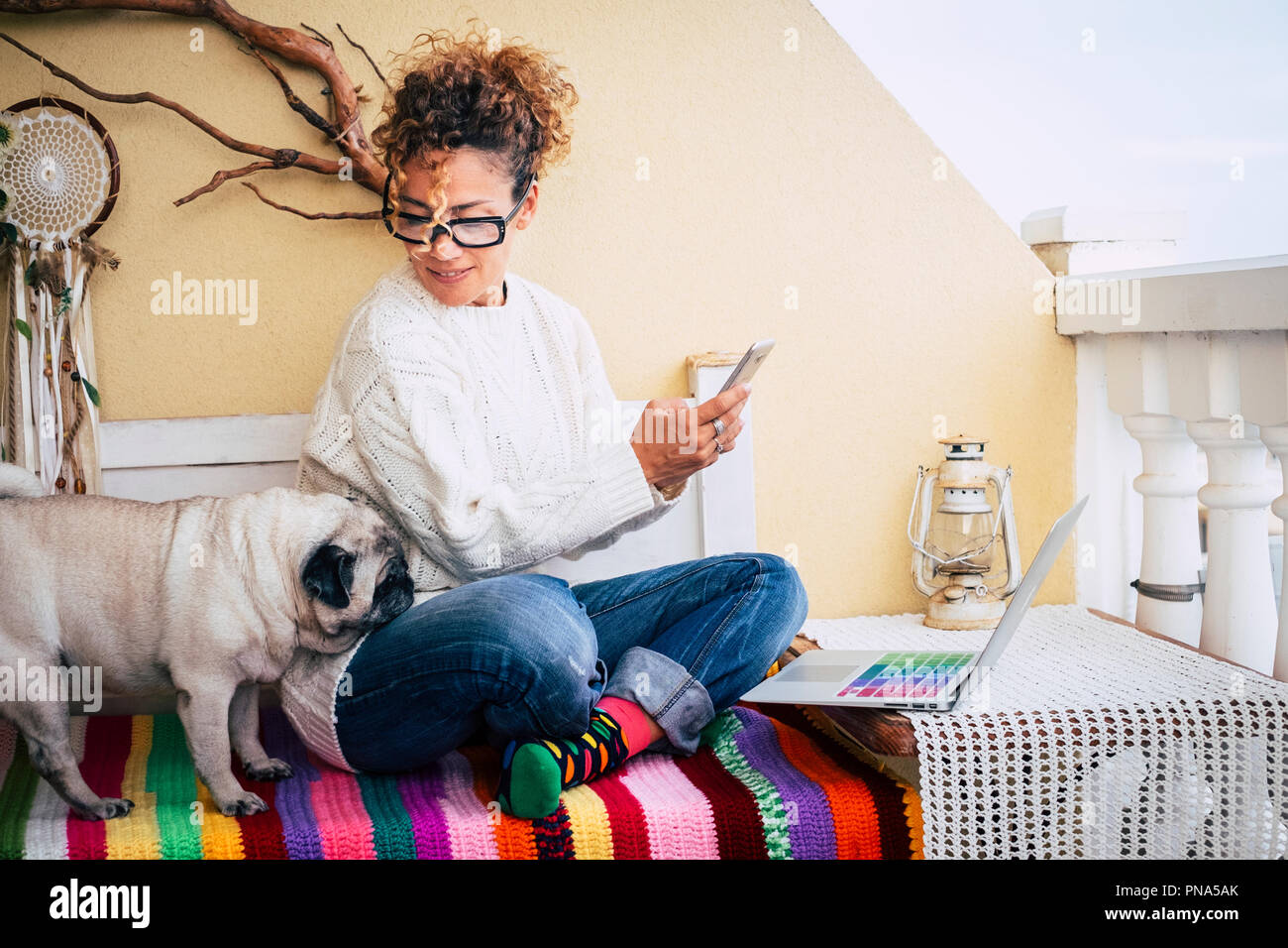 Happy alternative young cheerful woman warking at home with a new ...