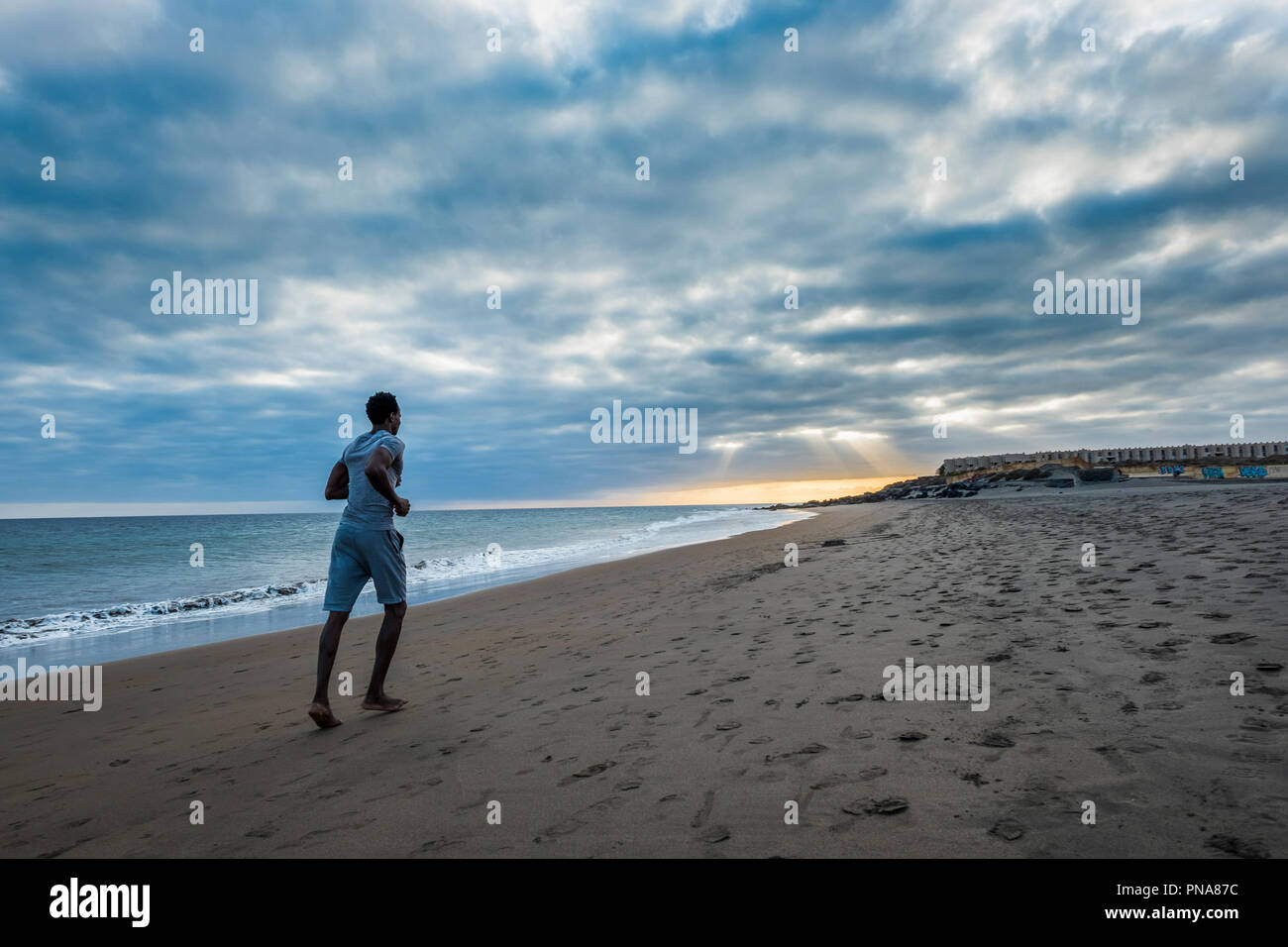 young black race african man run over the beach in fitness activity ...