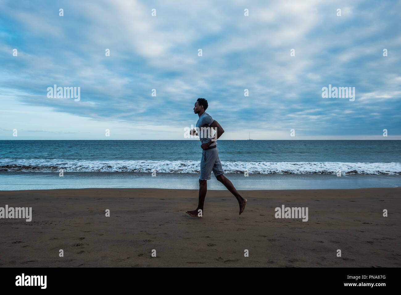 young black race african man run over the beach in fitness activity ...