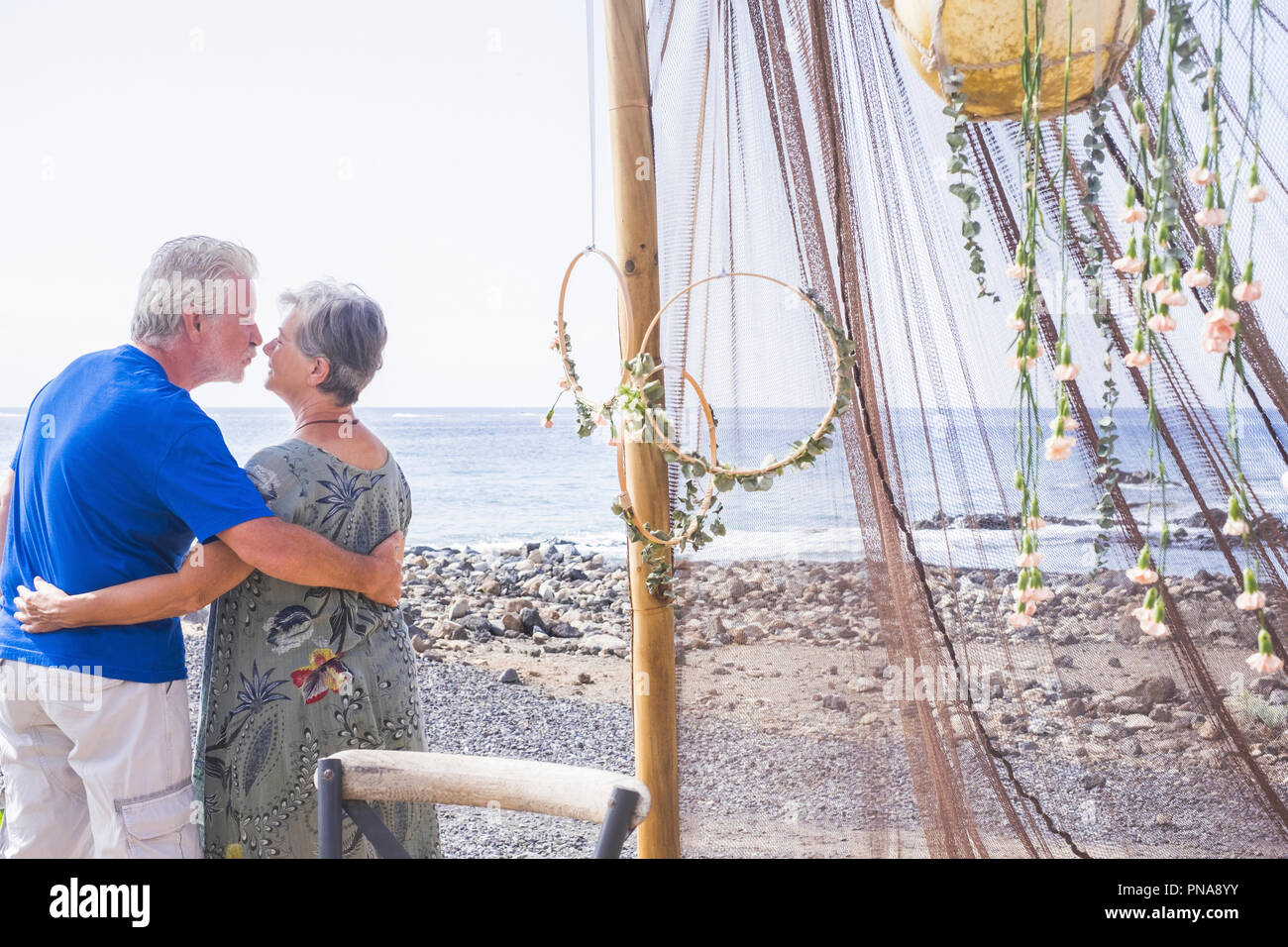 happy senior adult couple white hair stay together hugging and kissing ...