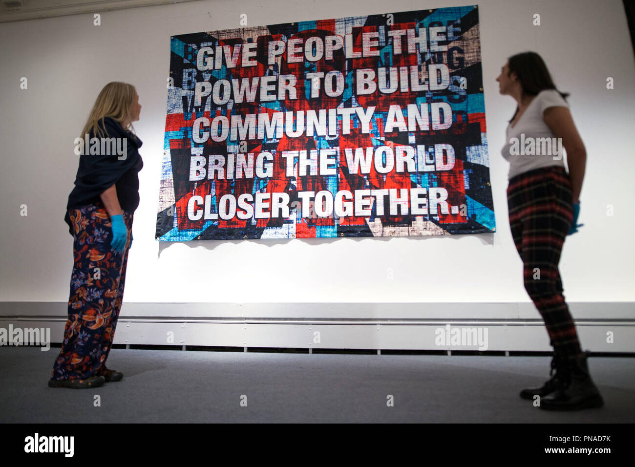 Gallery assistants observe Harvest, renew us! 2018, by Mark Titchner at ...