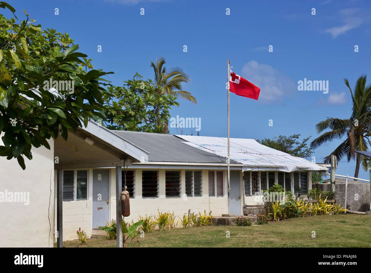 A Tongan flag above a Tongan school in a village Stock Photo - Alamy