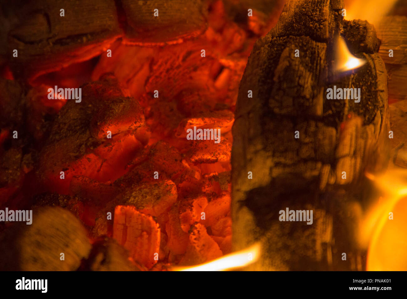 Glowing coal close-up pieces background Stock Photo - Alamy