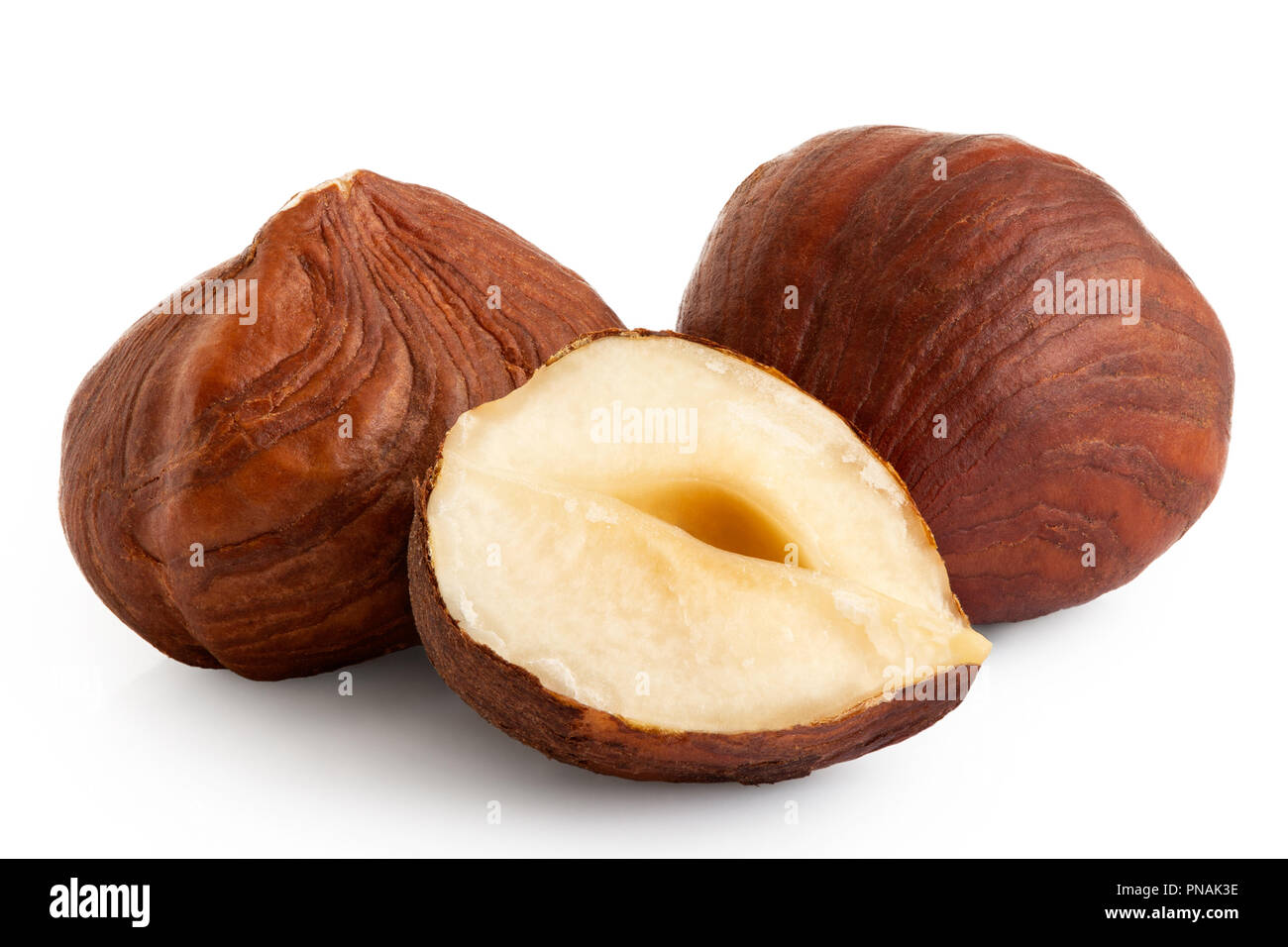 Two and half hazelnuts with skin isolated on white. Closeup Stock Photo ...