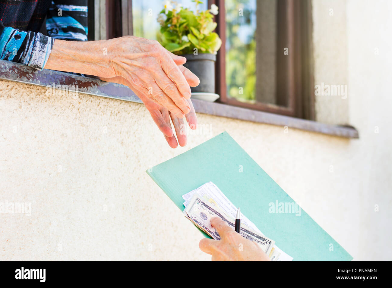 Senior woman receiving retirement check on the window at home Stock ...