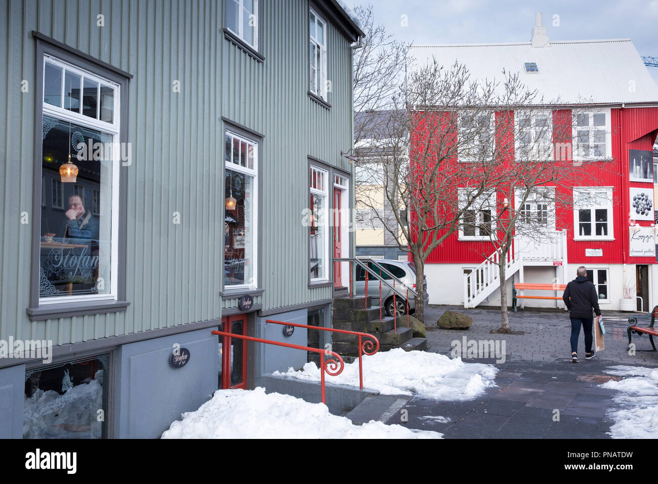 Typical buildings - cafe restaurant and shops - and melting snow in the ...