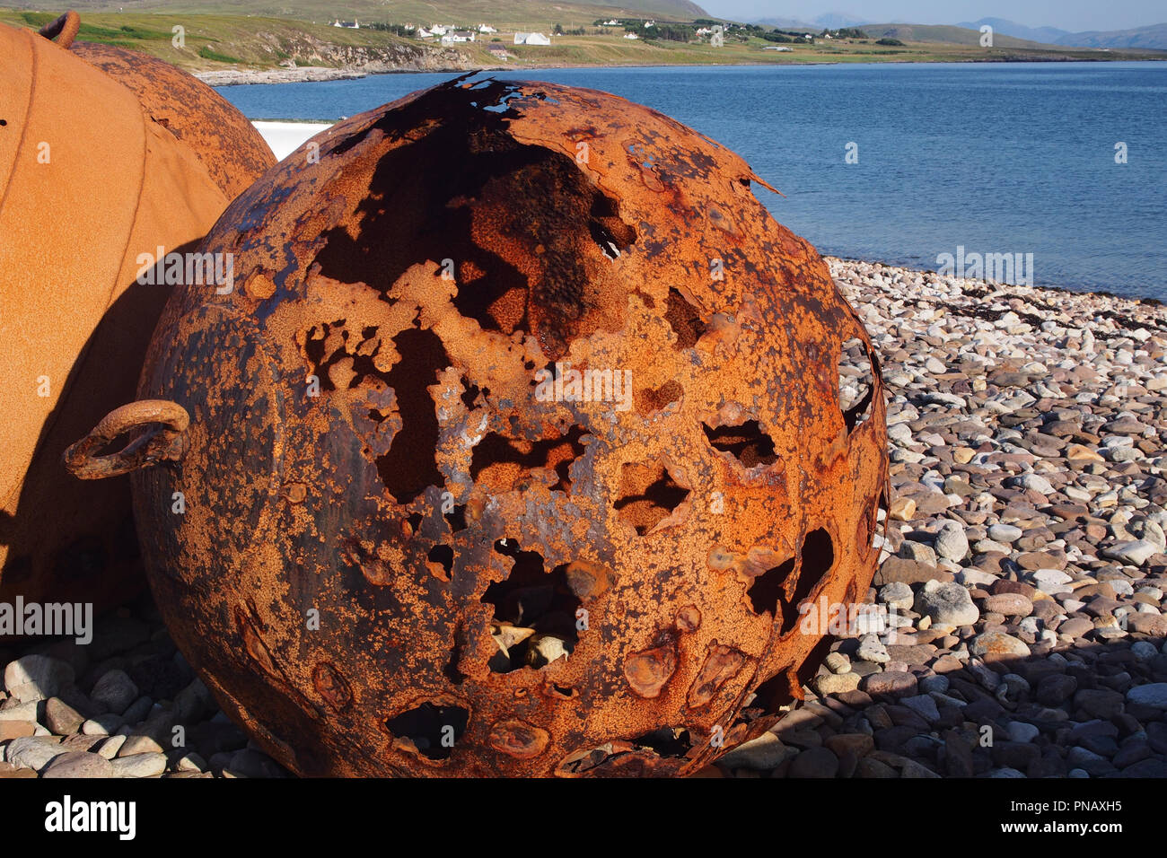 A view of broken, large, discarded iron sea floats on Badentarbat beach ...