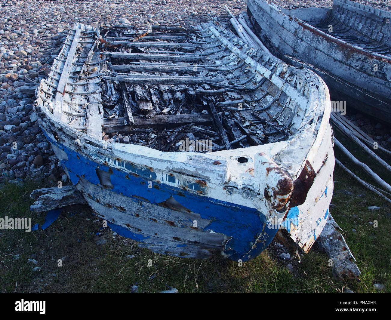 A view of the inside of the broken battered hull of a boat pulled up on ...