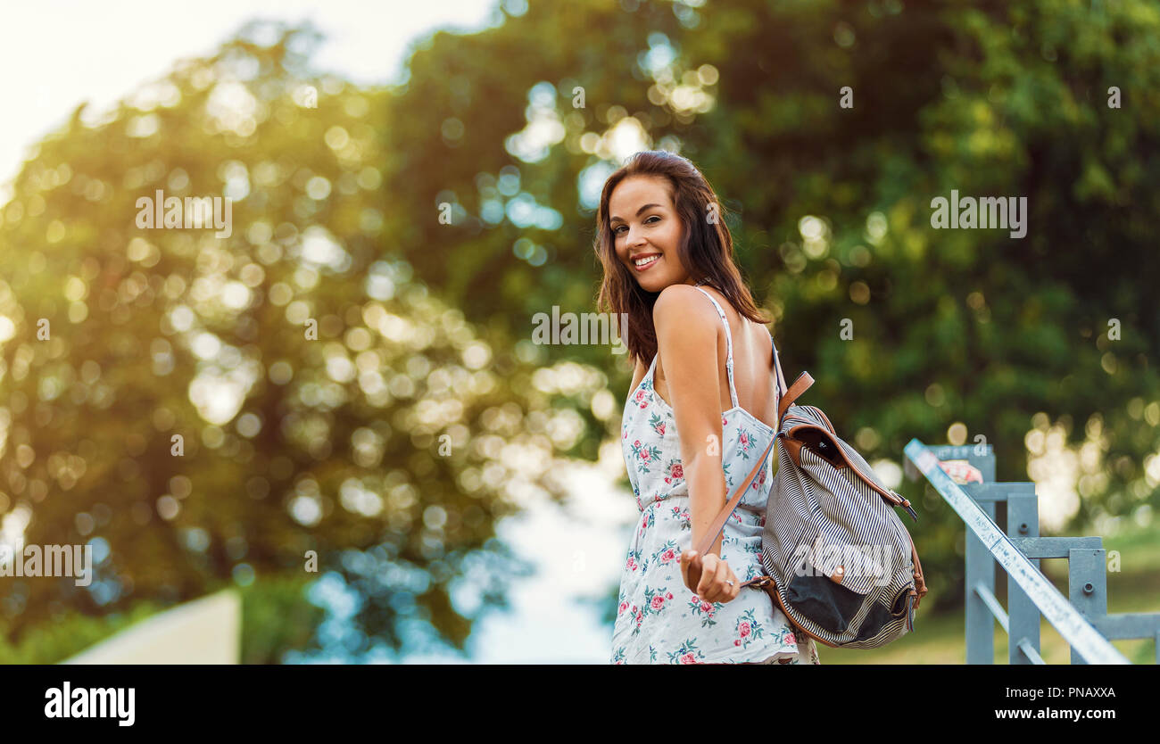 brunette woman looking back over shoulder Stock Photo - Alamy
