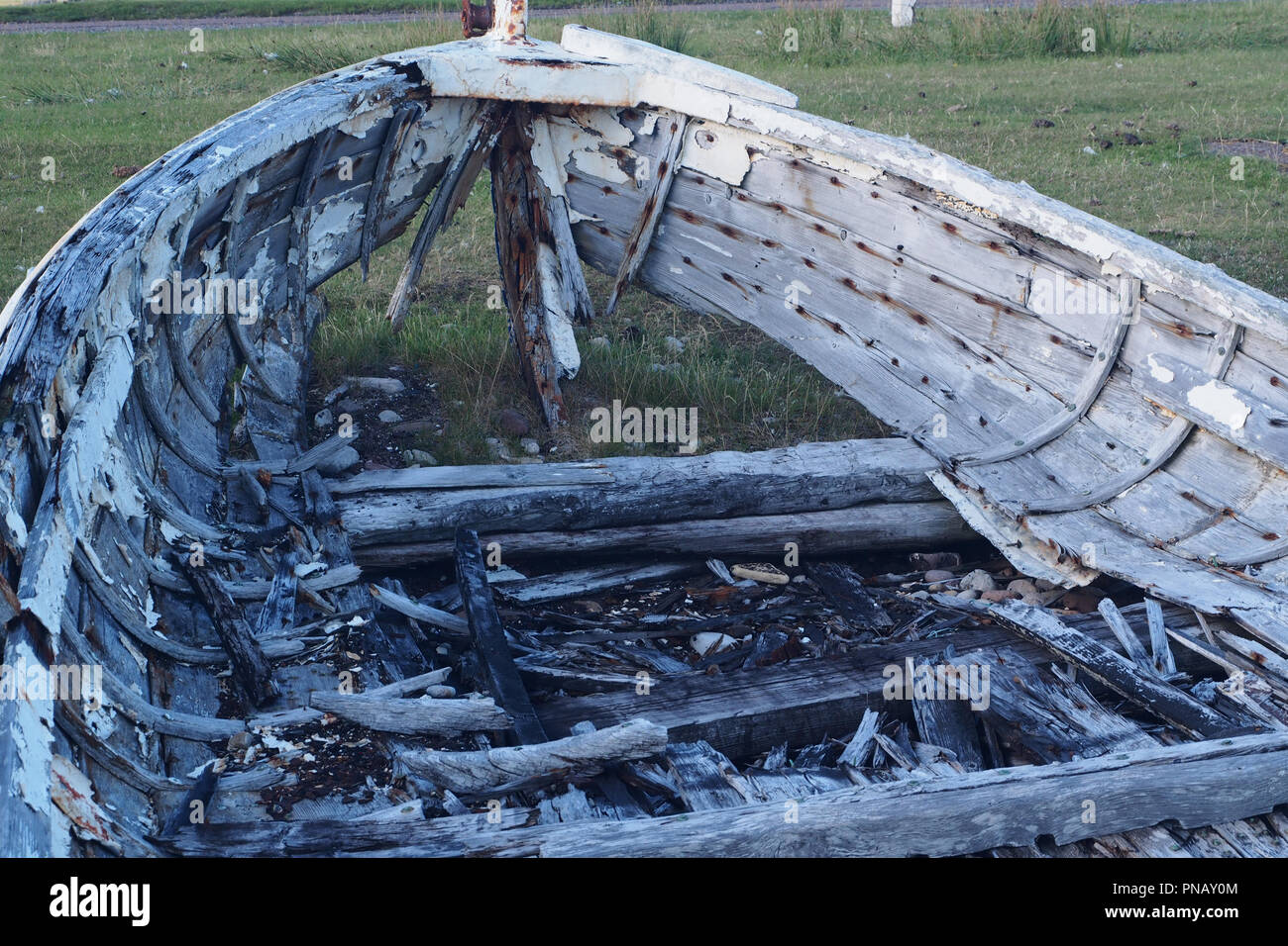 A view of the inside of the broken battered hull of a boat pulled up on ...