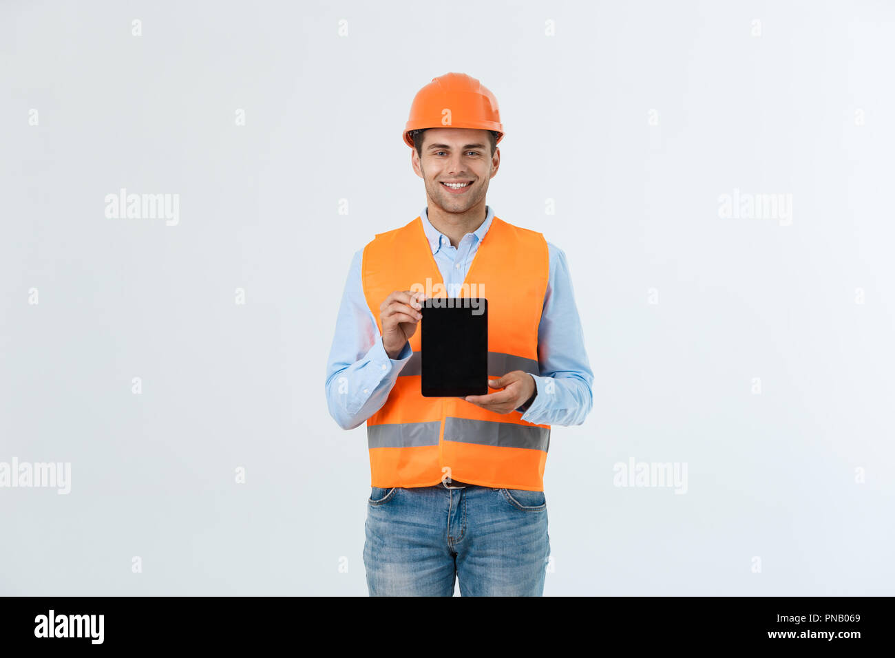 Engineer holding tablet mobile phone with blank black screen with copy ...
