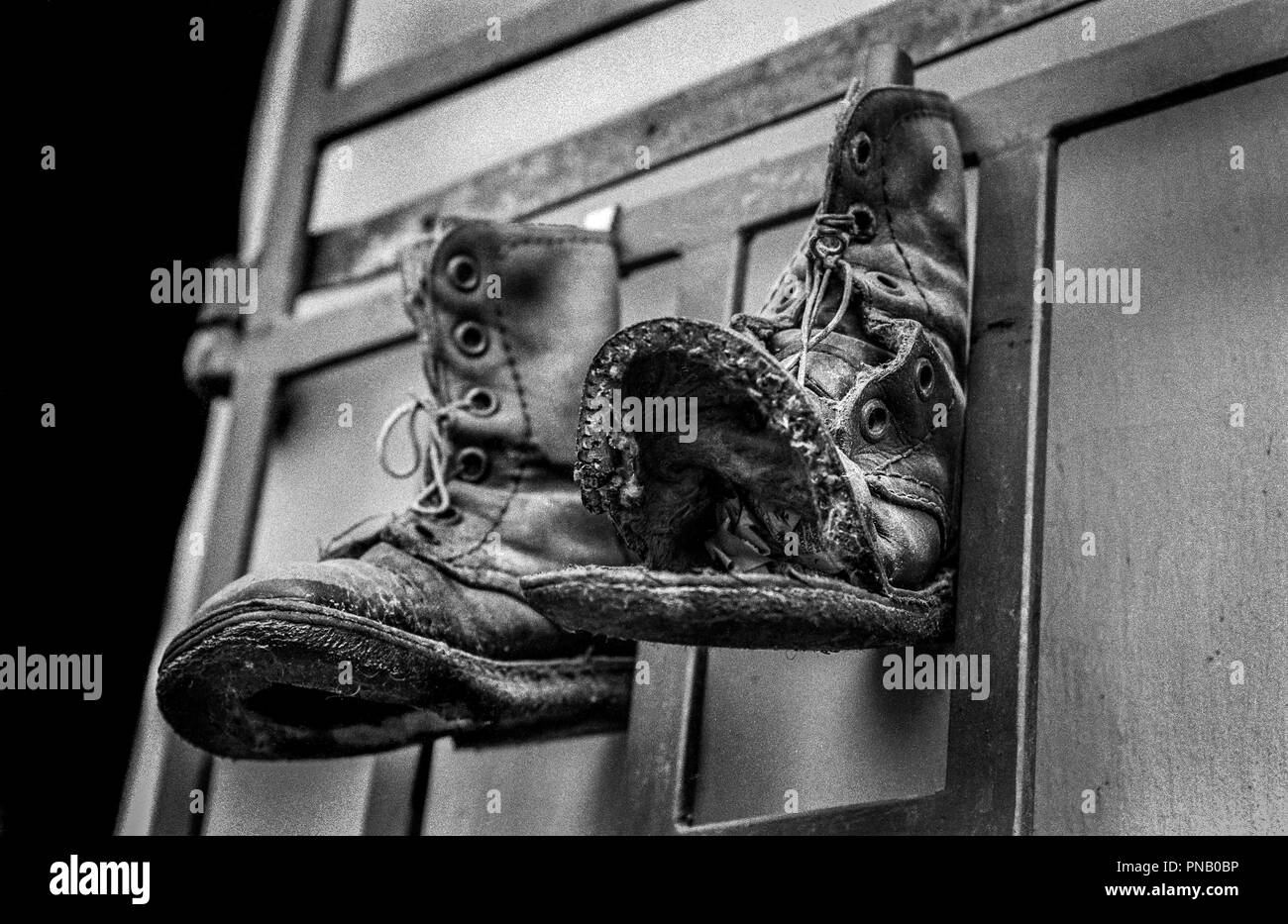 Army boots hanging in a doorway, Sarajevo Stock Photo - Alamy