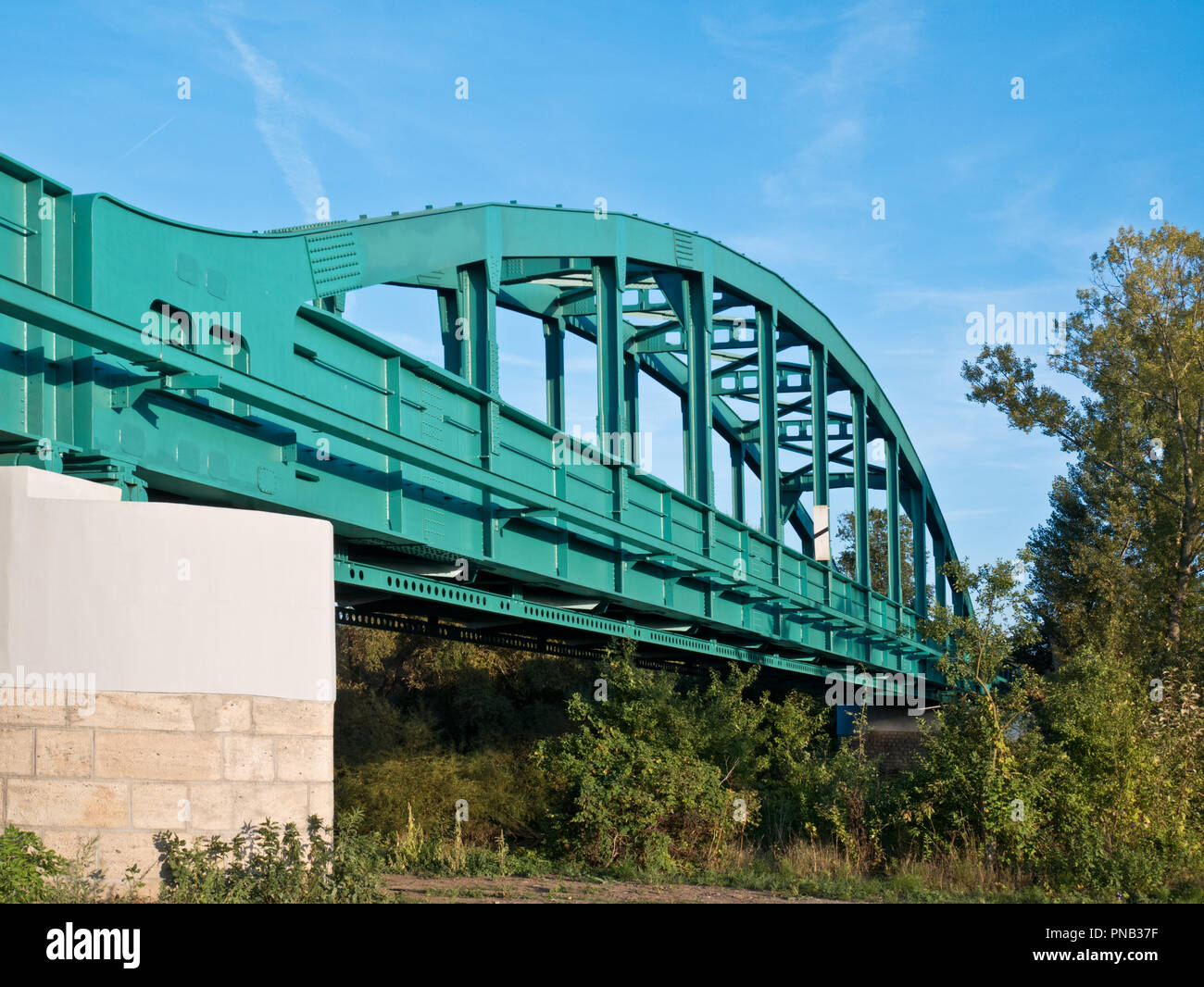 Metal bridge over river in the summer time Stock Photo - Alamy
