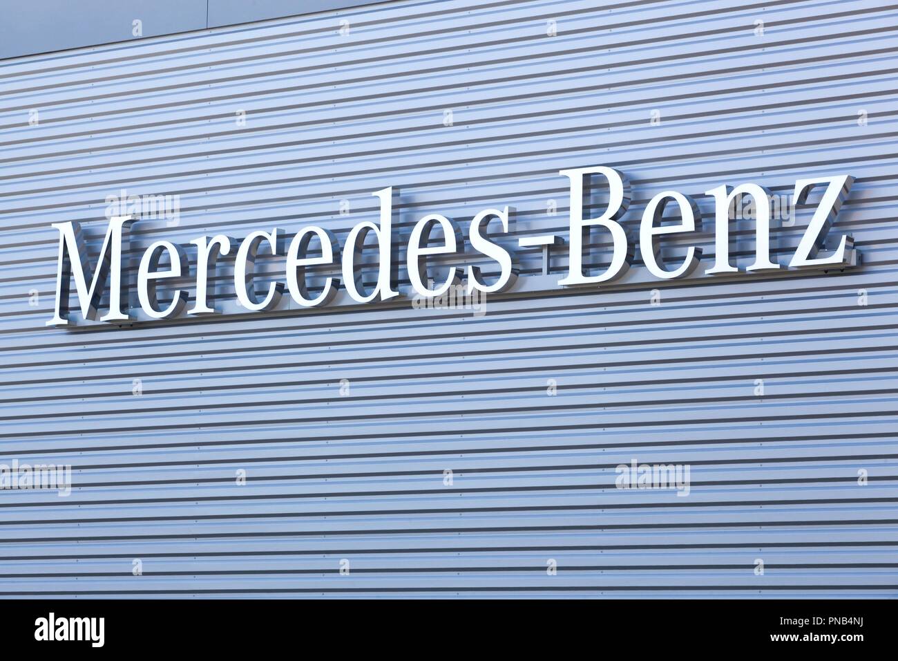 Saint Priest, France - September 8, 2018: Mercedes-Benz logo on a wall. Mercedes-Benz is a ...