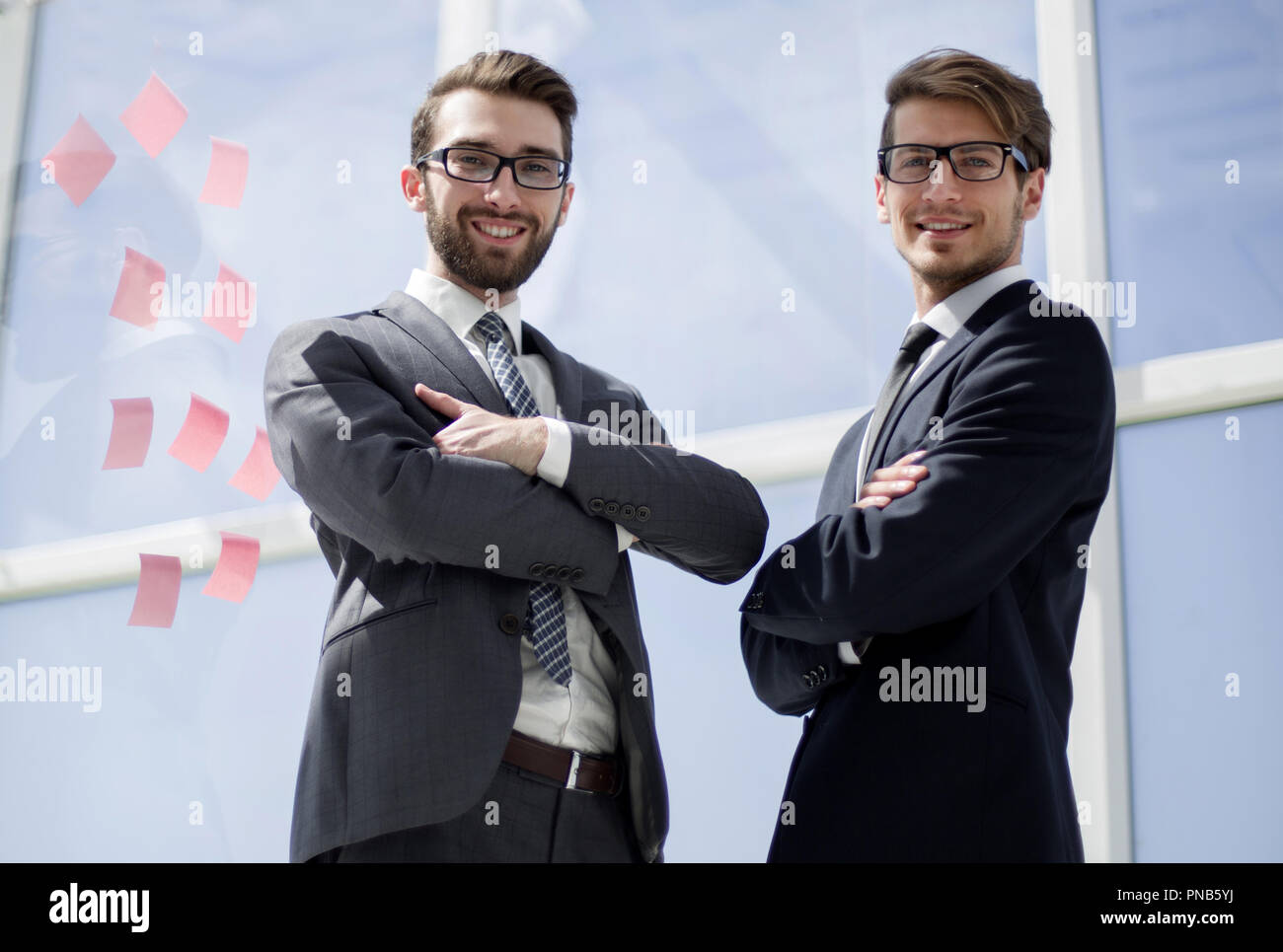 two successful business people standing in the office Stock Photo - Alamy
