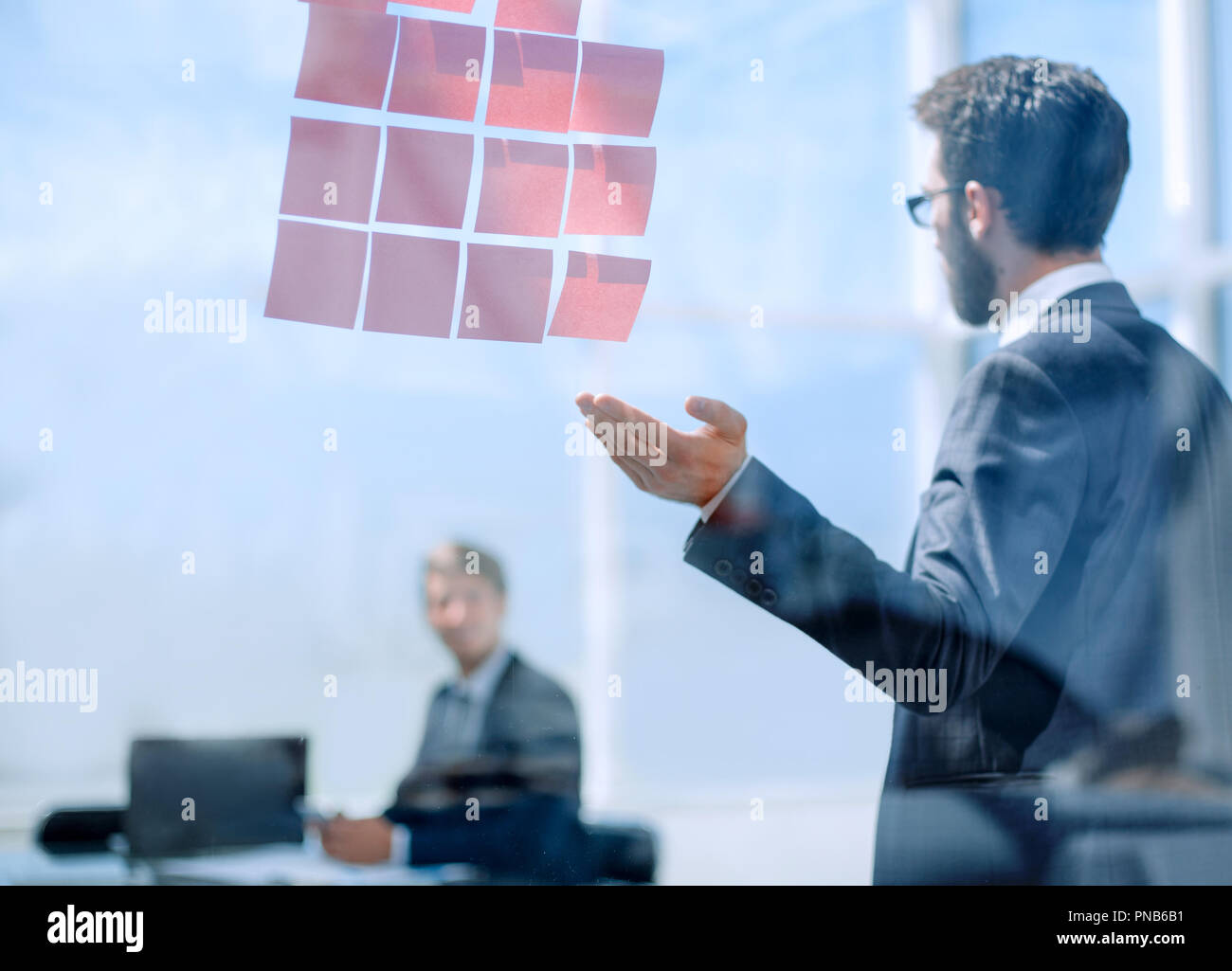 Manager pointing at the glass office Board Stock Photo - Alamy