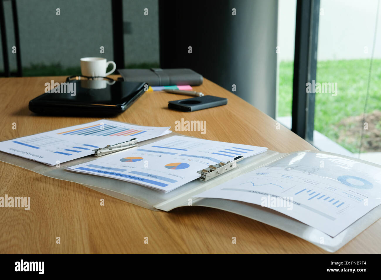 computer laptop document on wood office desk near window. working space ...