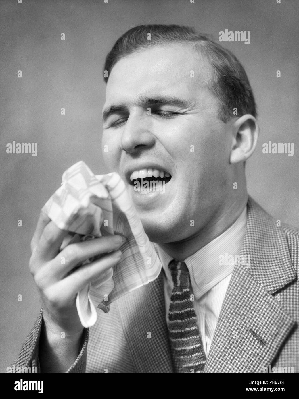 1930s MAN EYES CLOSED MOUTH OPEN HANDKERCHIEF IN HAND ABOUT TO SNEEZE ...